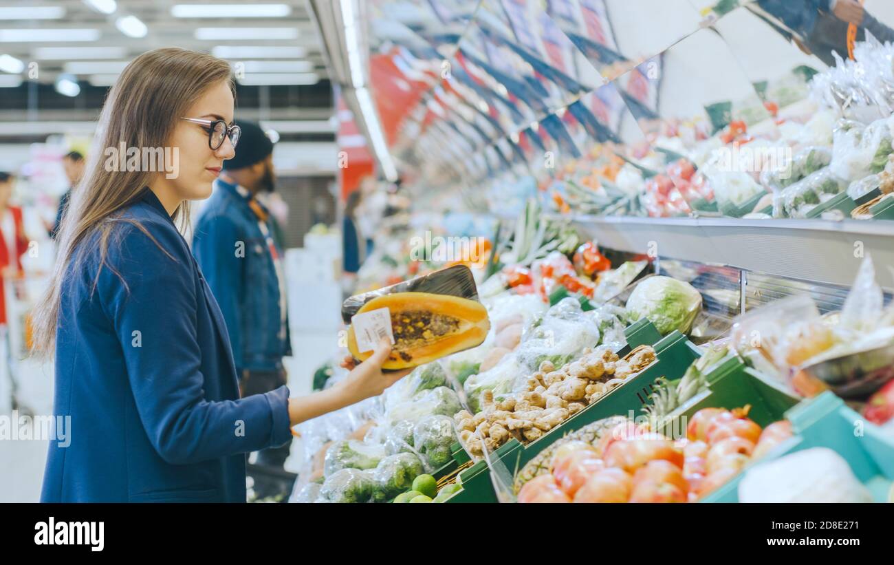 At the Supermarket: Beautiful Young Woman Stands in the Fresh Produce ...