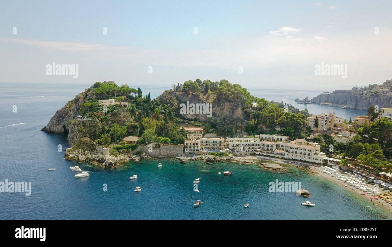 View over the beaches of Taormina, Italy, with turquoise sea and a ...