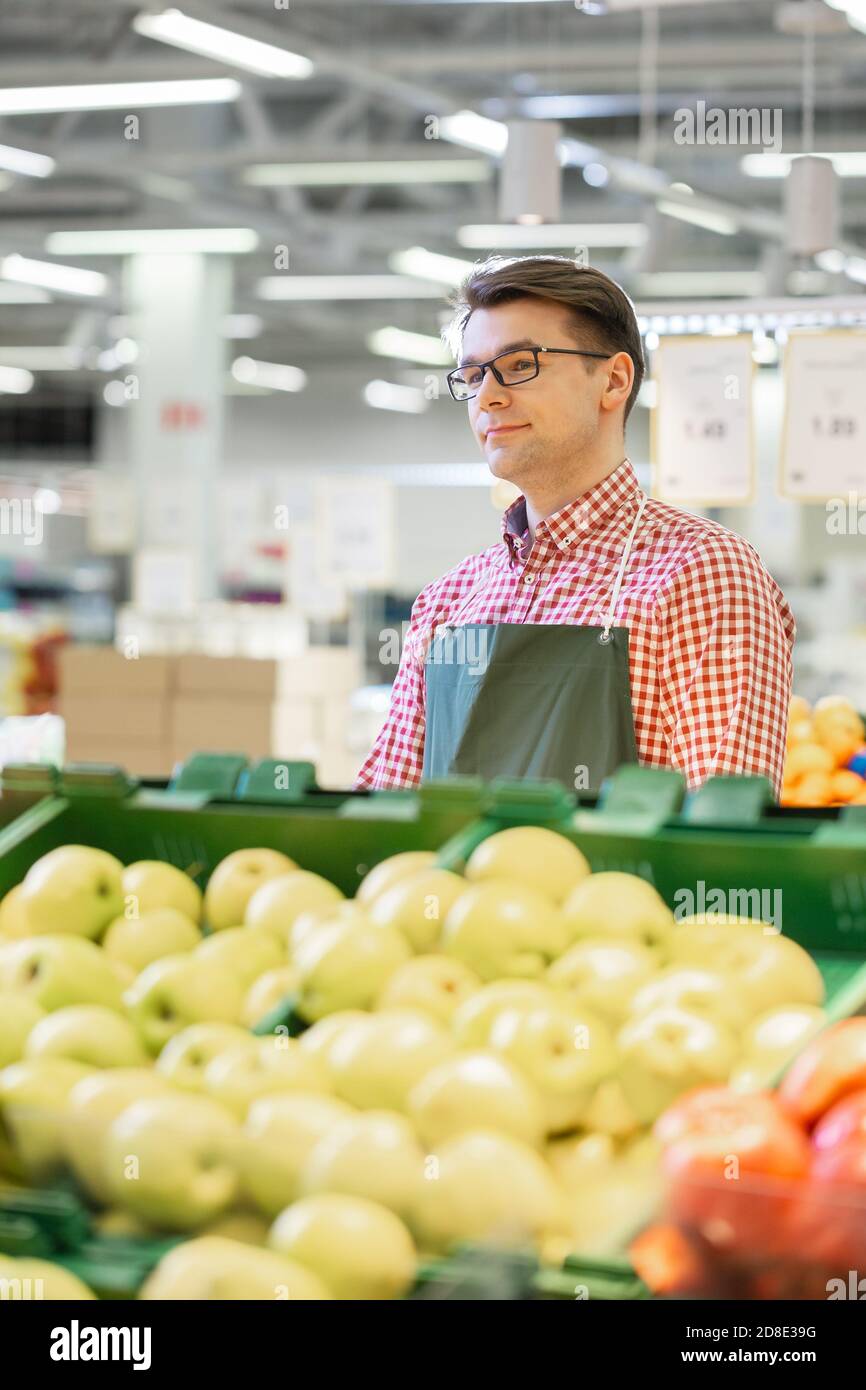 At the Supermarket: Portrait Of the Smiling Stock Clerk Wearing Apron ...