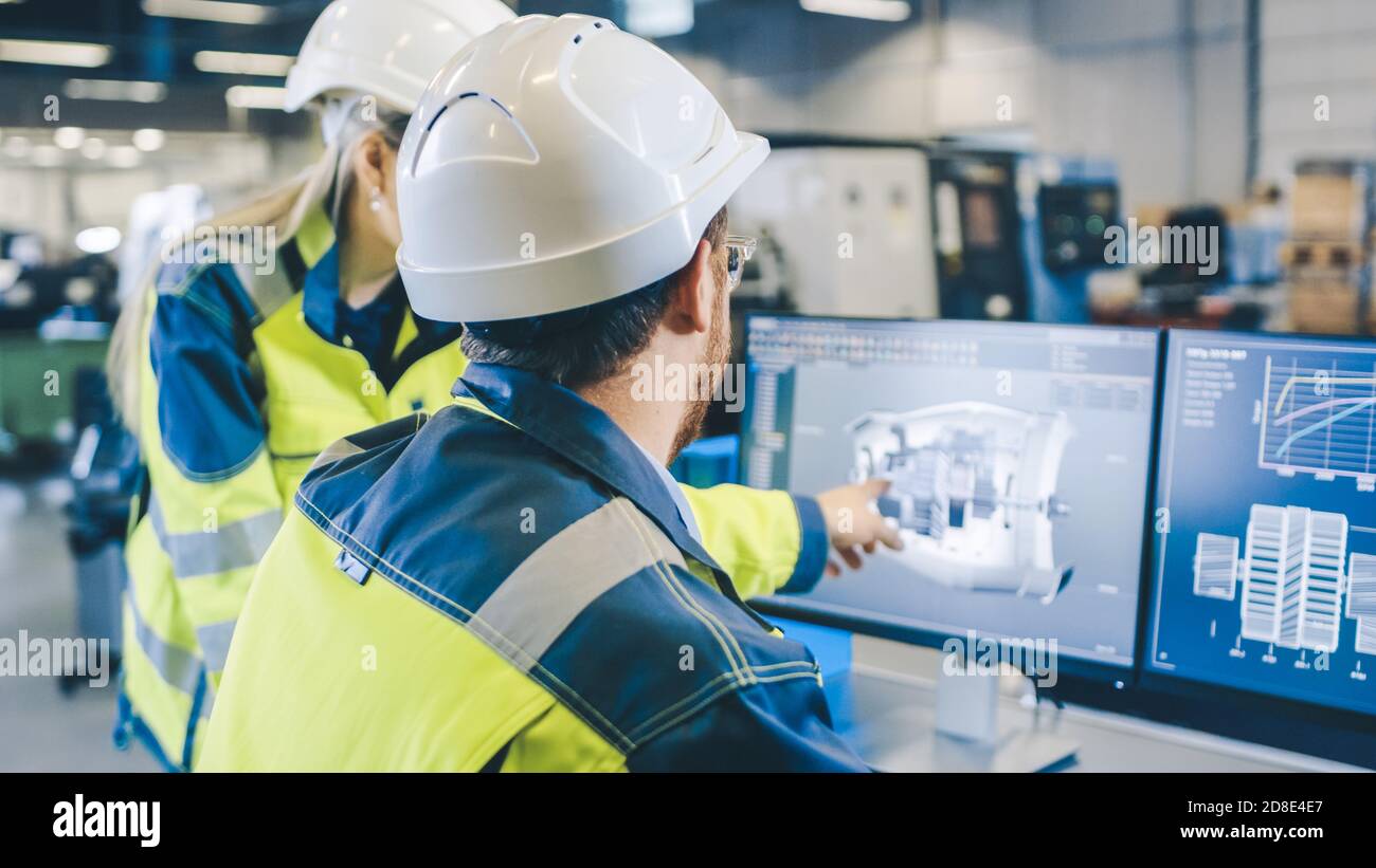 At the Factory: Male Mechanical Engineer and Female Chief Engineer Work ...