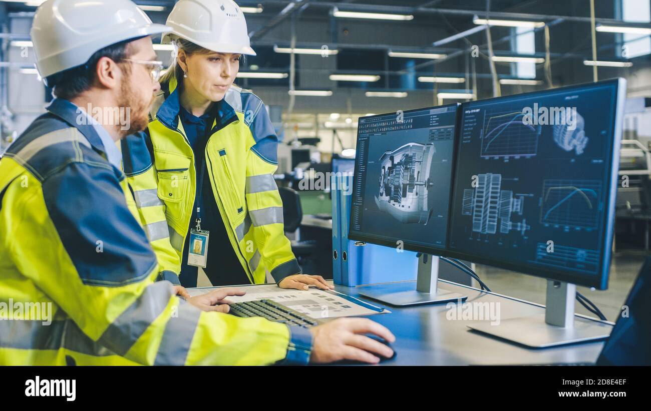 At the Factory: Male Mechanical Engineer and Female Chief Engineer Work ...