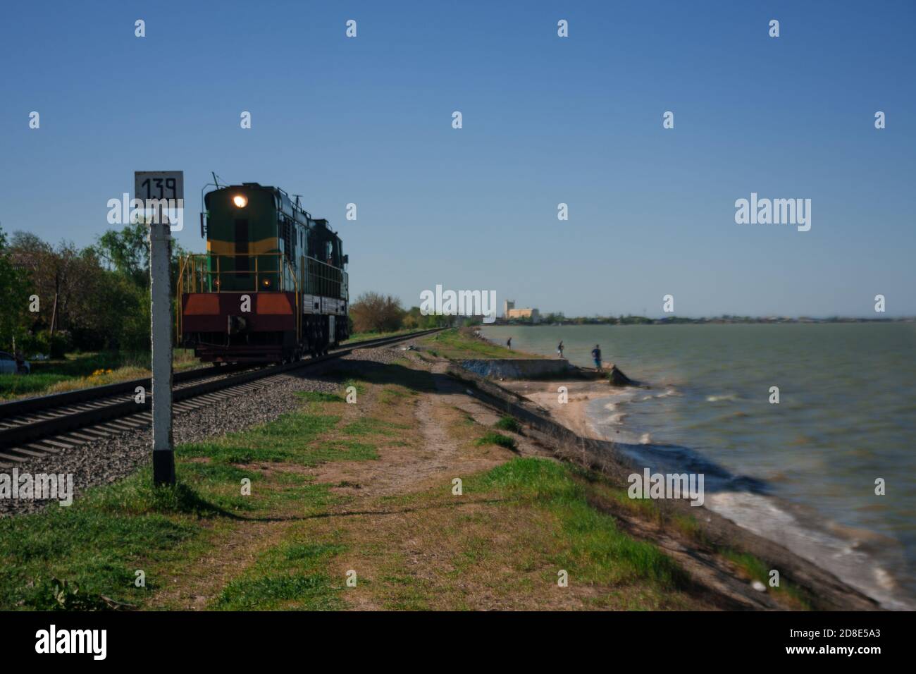 Old green train on the railway along the seaside Stock Photo - Alamy
