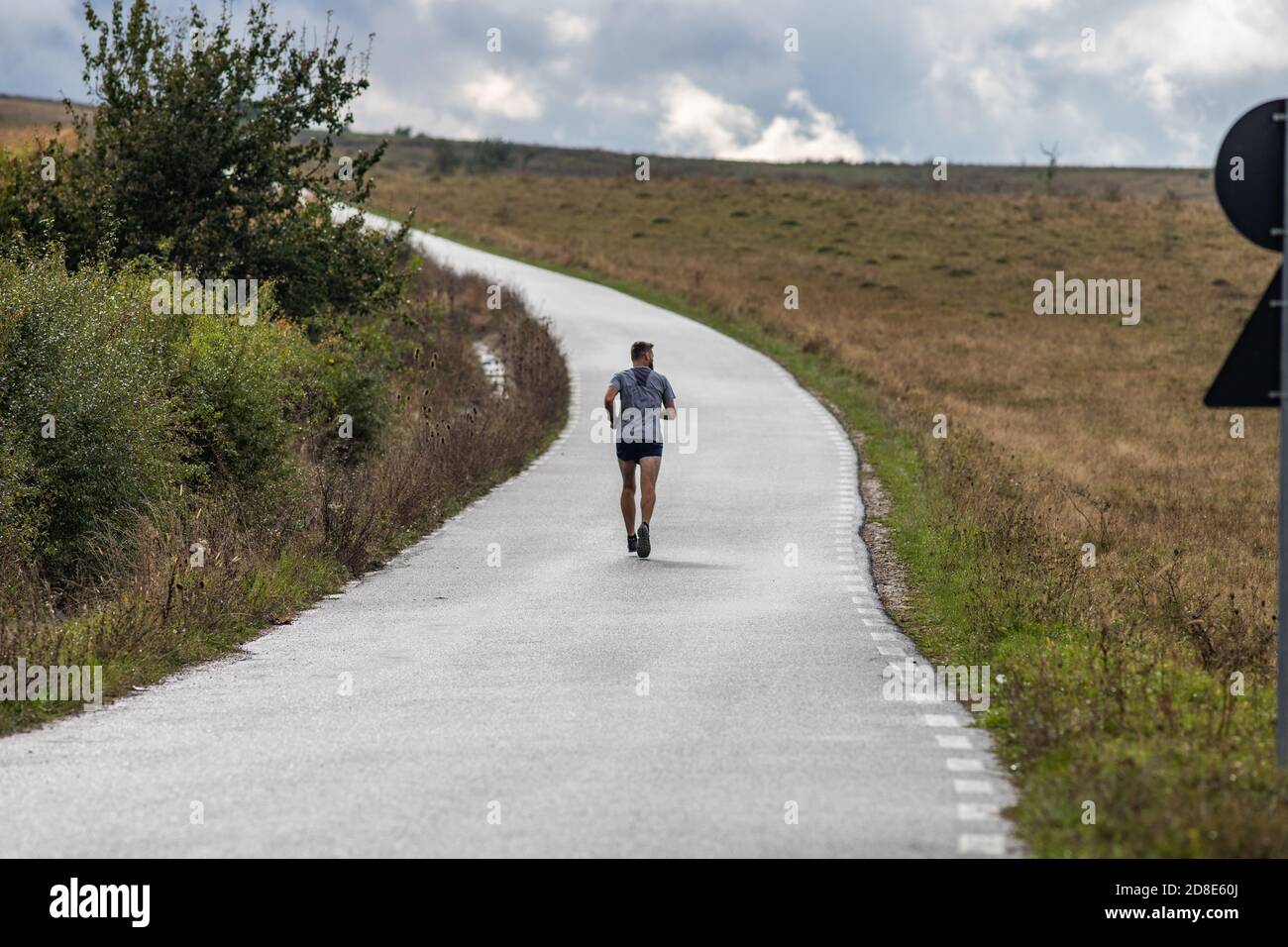young man running on country road Stock Photo - Alamy