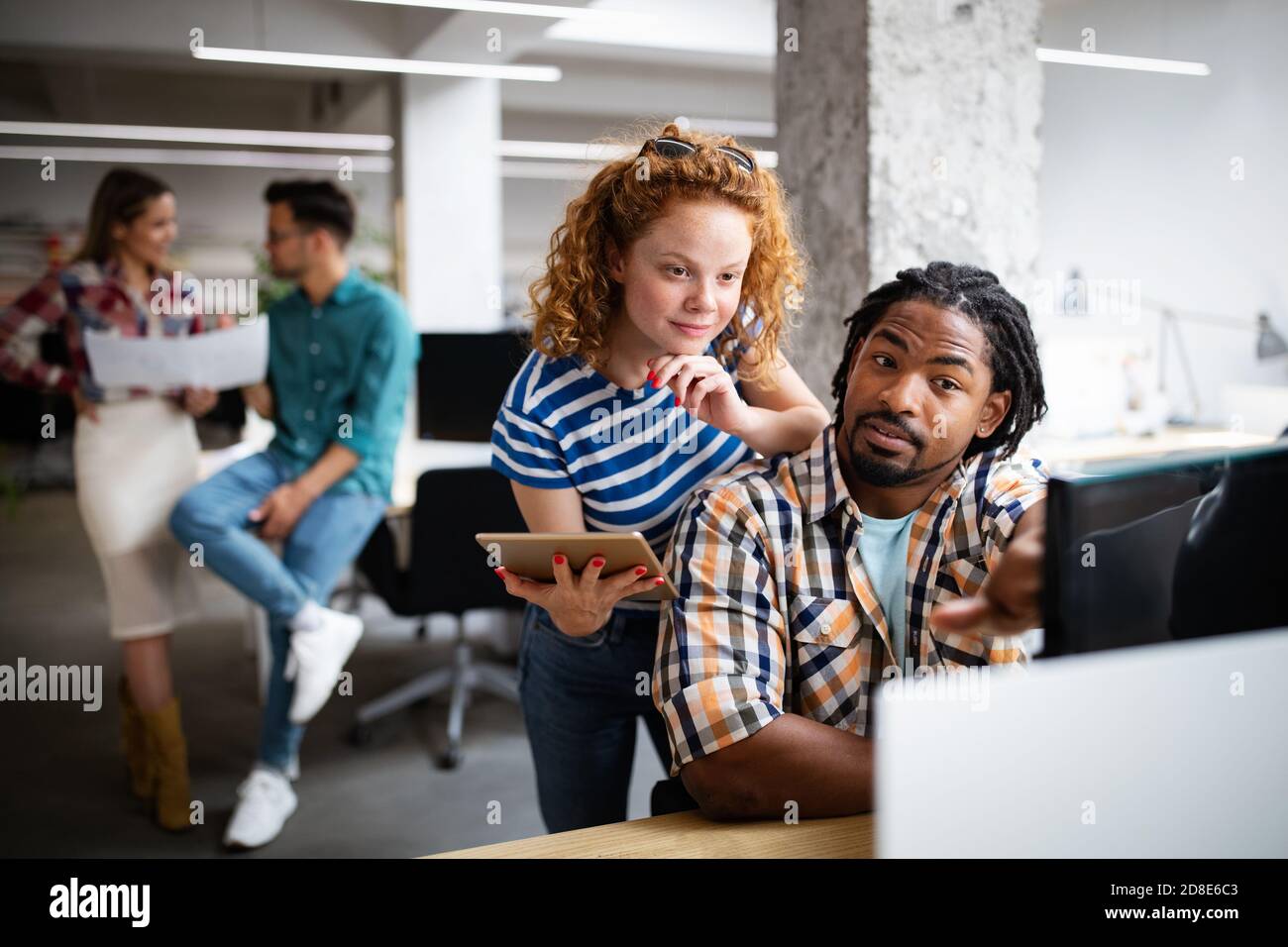 Programmers cooperating at IT company developing apps Stock Photo - Alamy