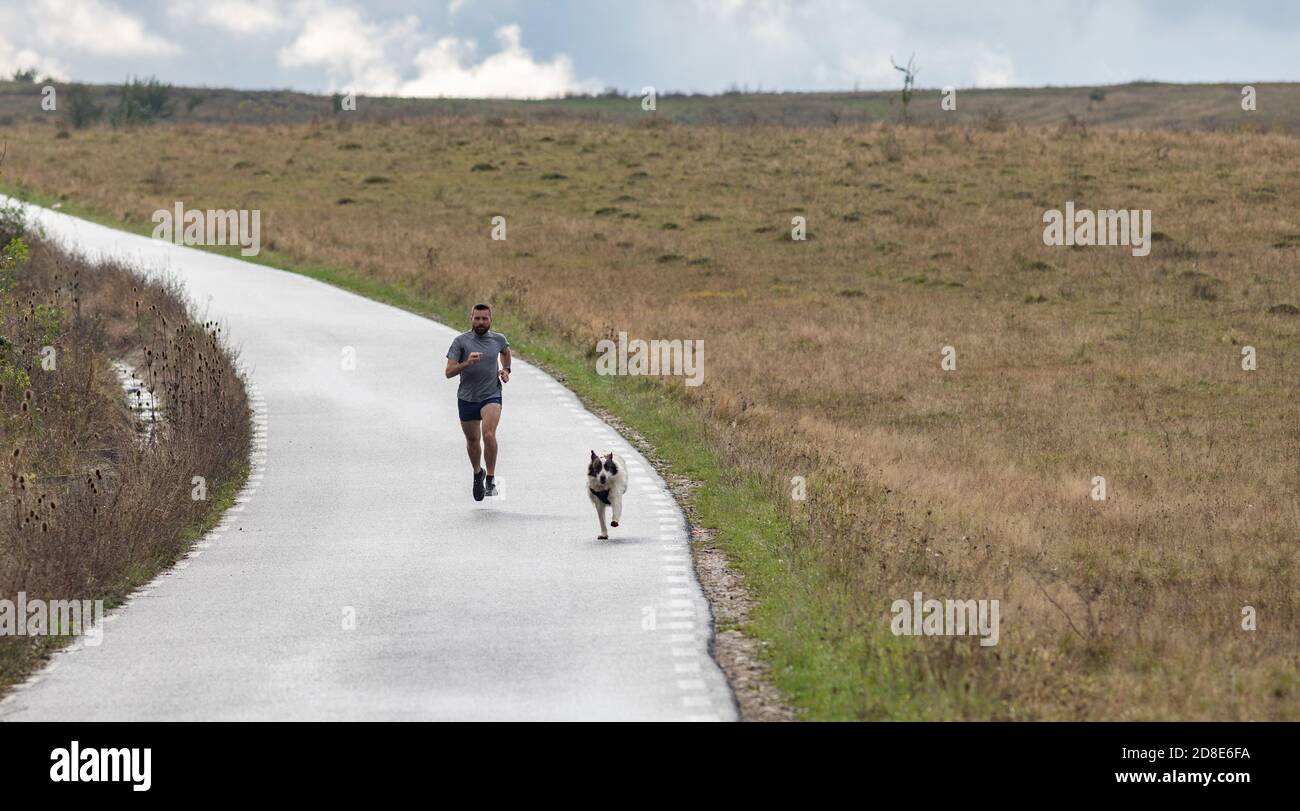 young man running on country road Stock Photo - Alamy
