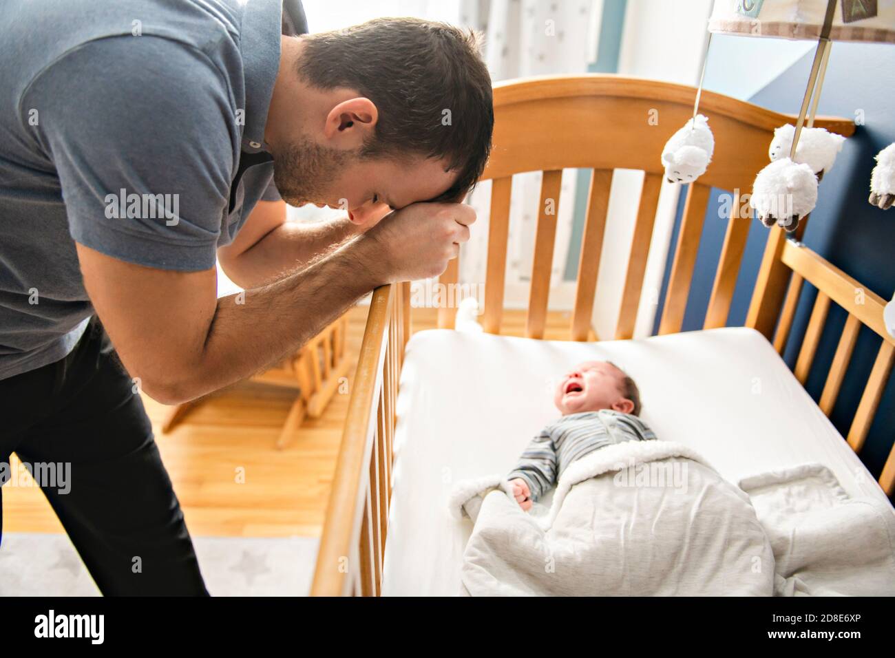 Tired father with Upset Baby Suffering with Post Natal Depression Stock ...