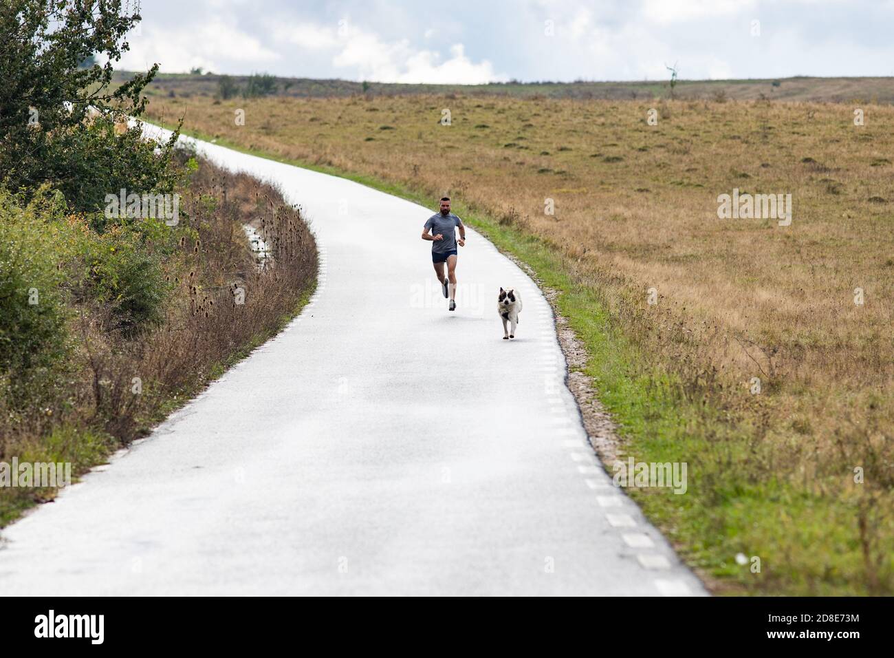 young man running on country road Stock Photo - Alamy