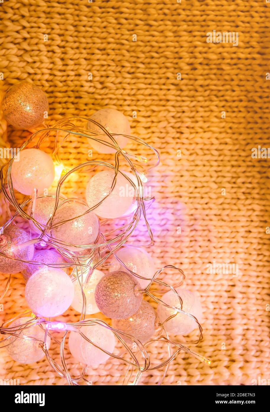 Christmas lights garland with round lanterns on knitted fabric ...