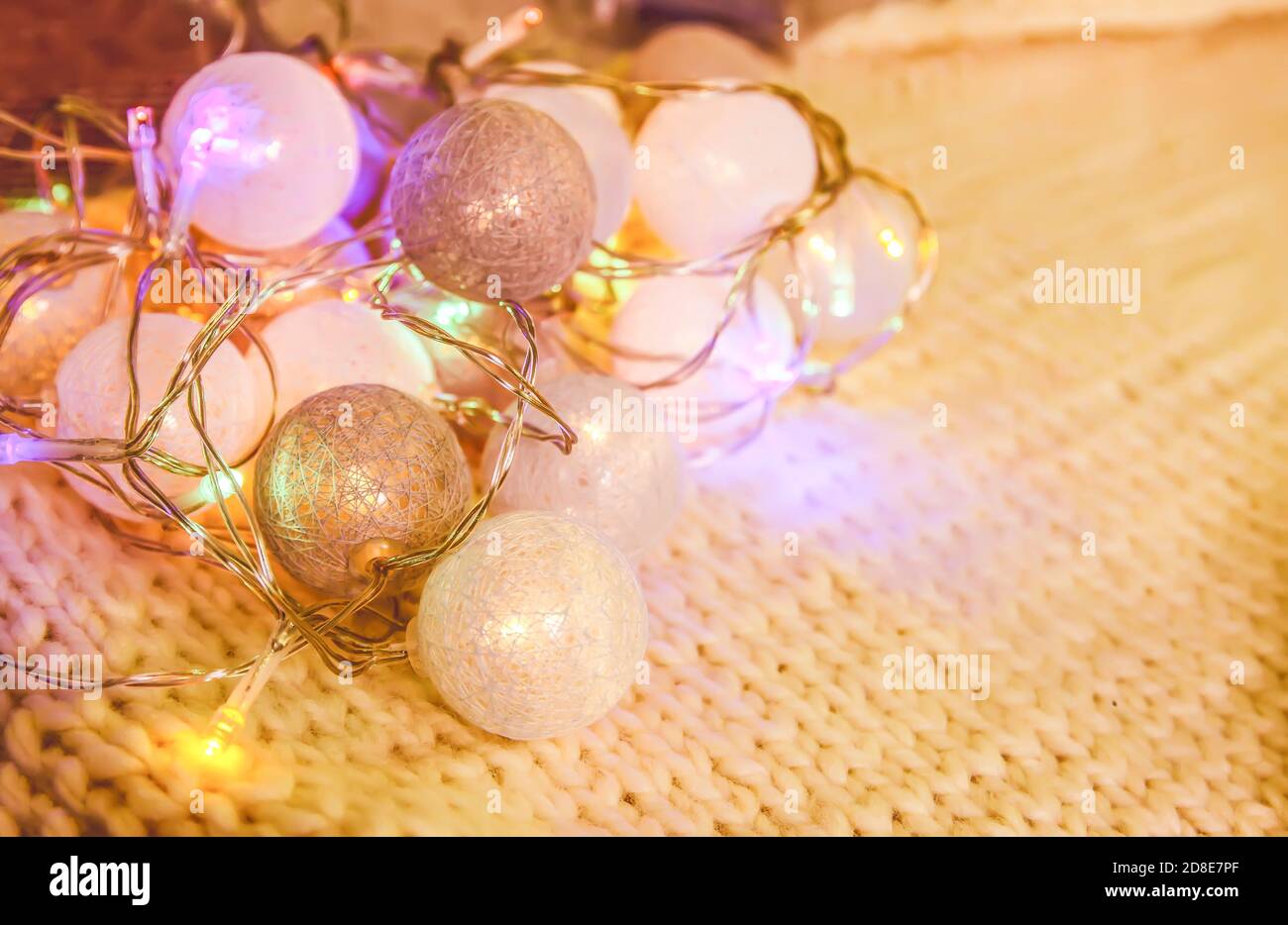 Christmas lights garland with round lanterns on knitted fabric ...