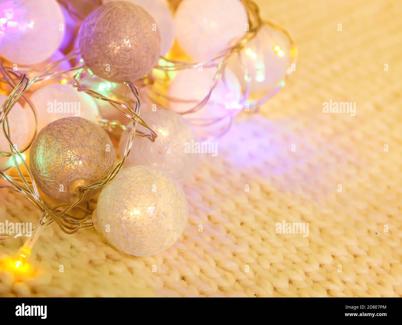 Christmas lights garland with round lanterns on knitted fabric ...