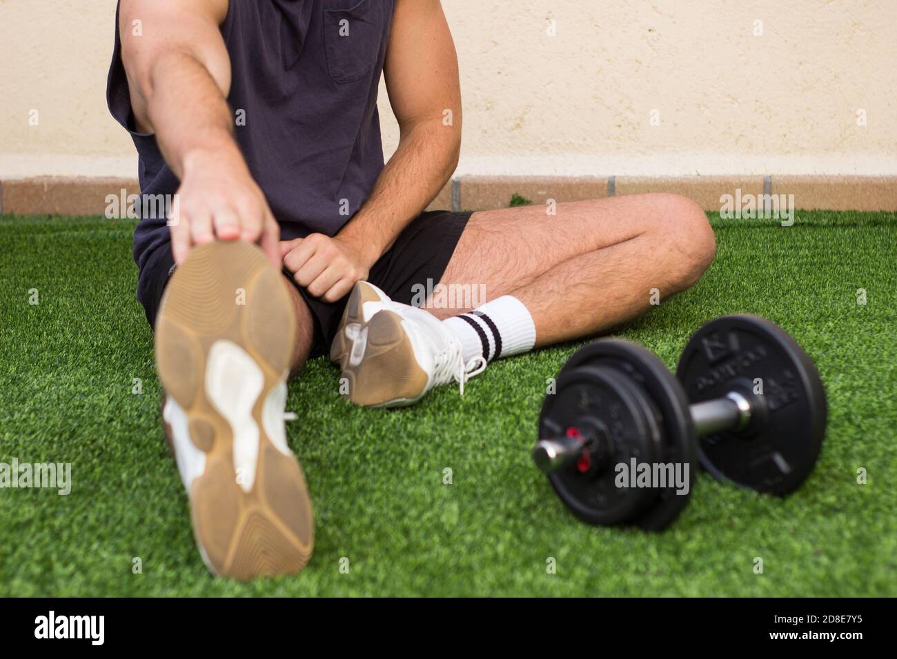 Athlete during muscle stretching hi-res stock photography and images ...