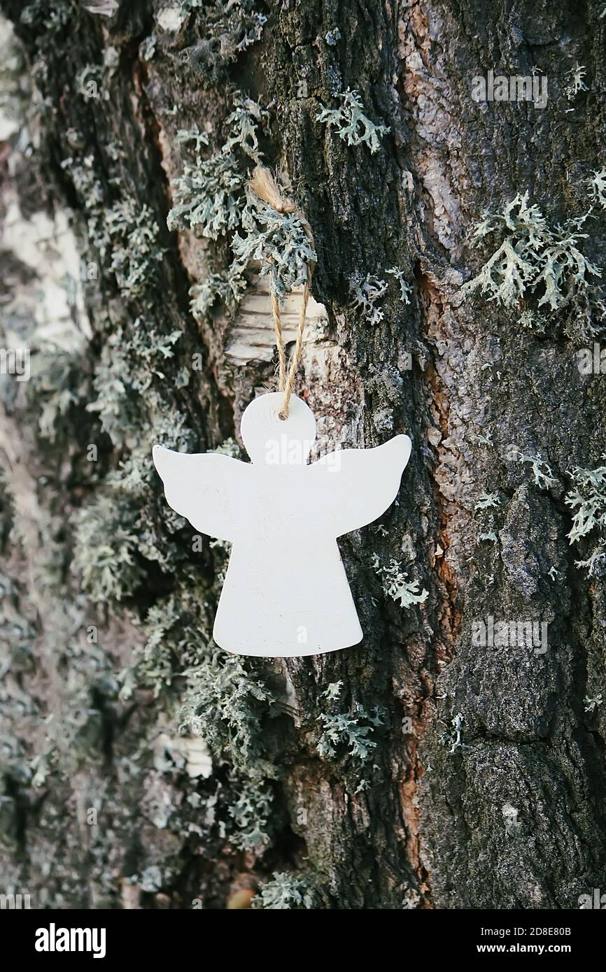 Wooden decoration angel white figure on tree barkbackground Stock Photo ...