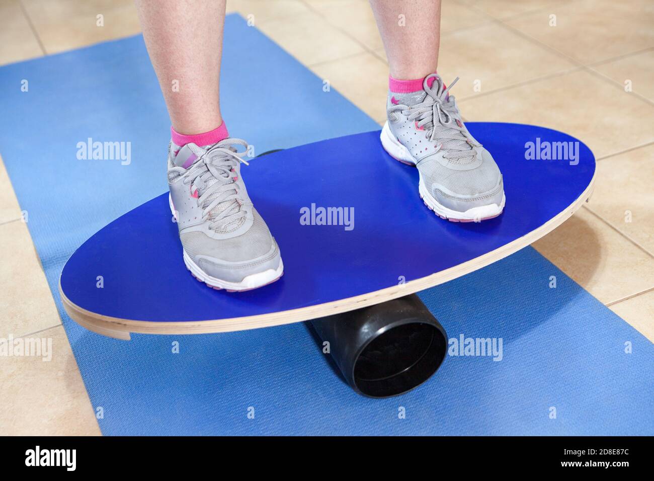 Doing exercises on balance board, person balancing and holding ...