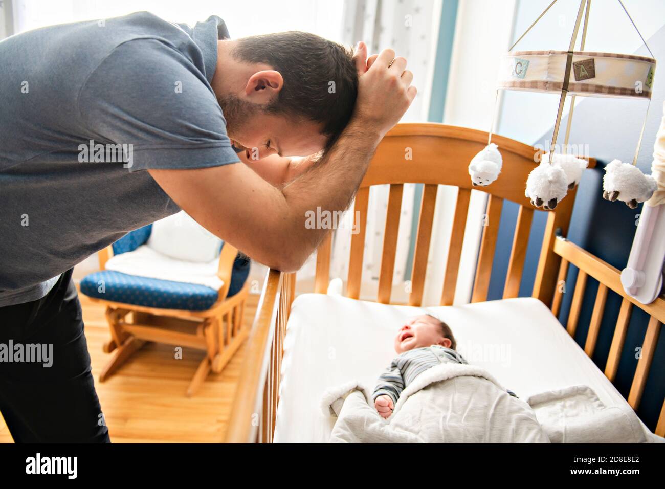 Tired father with Upset Baby Suffering with Post Natal Depression Stock ...