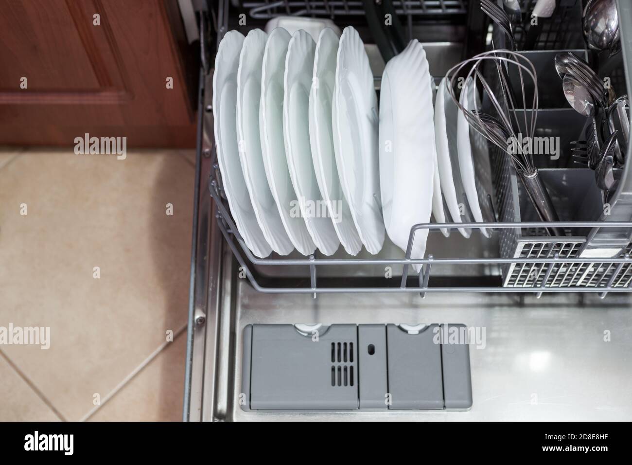 Dishwasher is loaded with utensils, clear dishes after washing, top ...