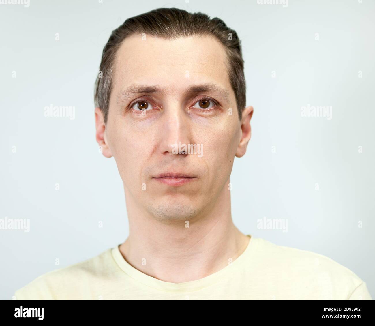 Portrait of a calm, balanced man, grey background, emotions series ...