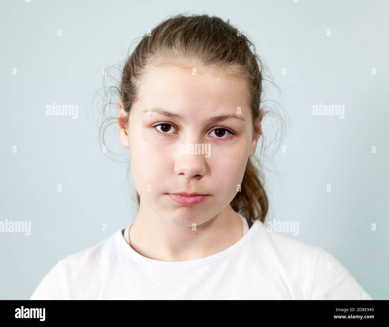 Young Caucasian girl with a sad expression on her face. Portrait on ...