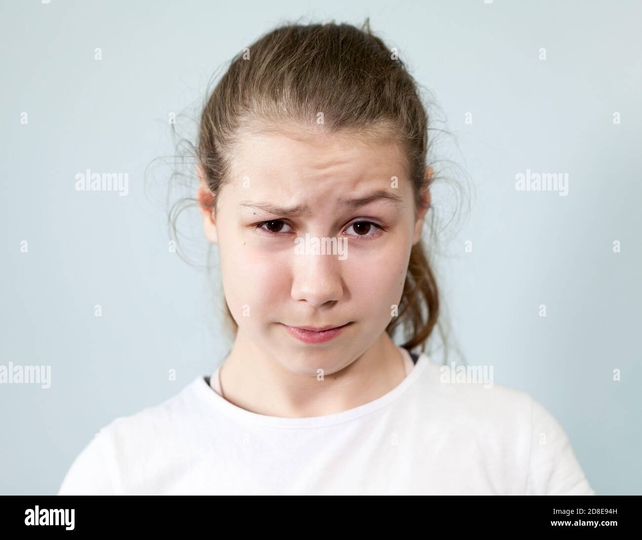 Confusion, misunderstanding on the face of a teenage girl, background ...