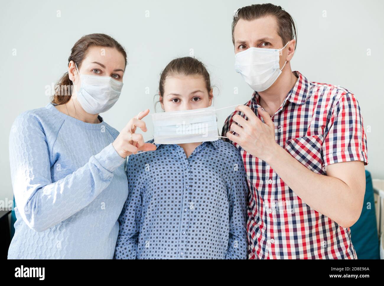 Parents dress medical mask on face of teenage daughter, father and ...