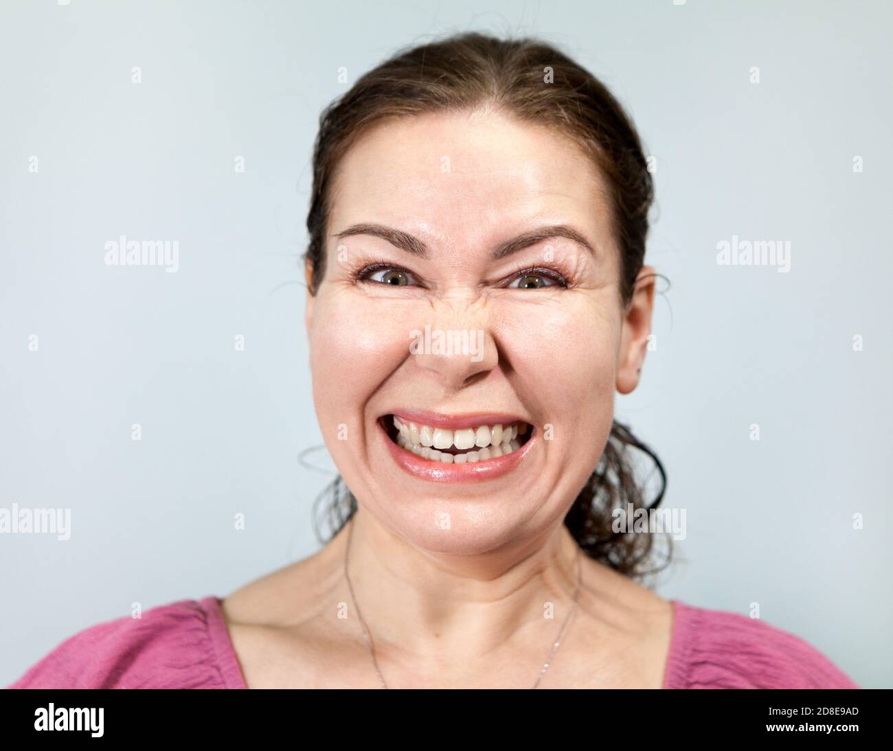 Grinning adult woman with teeth, angry and annoyed person, portrait on ...