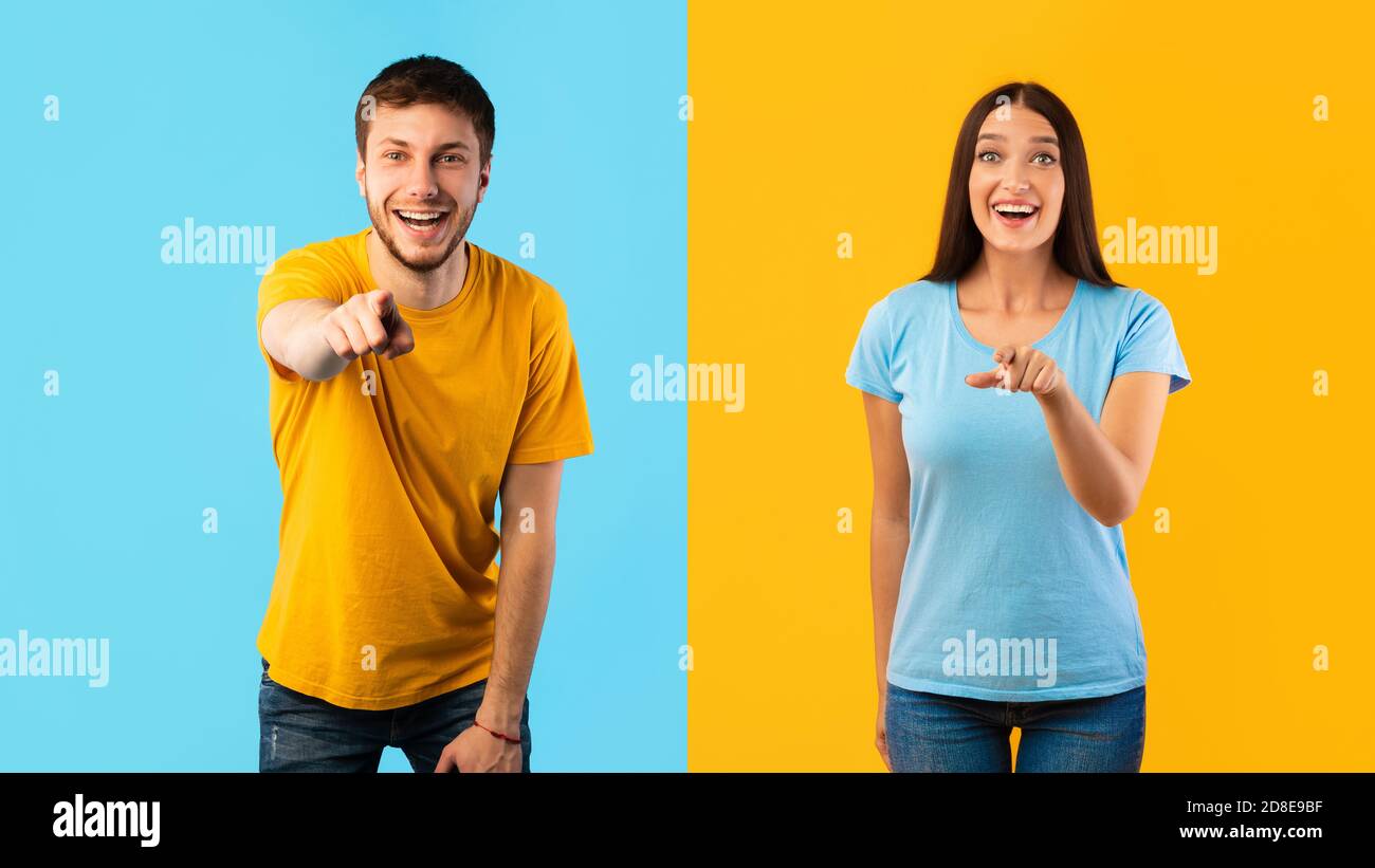 Happy couple pointing finger at camera at studio Stock Photo - Alamy