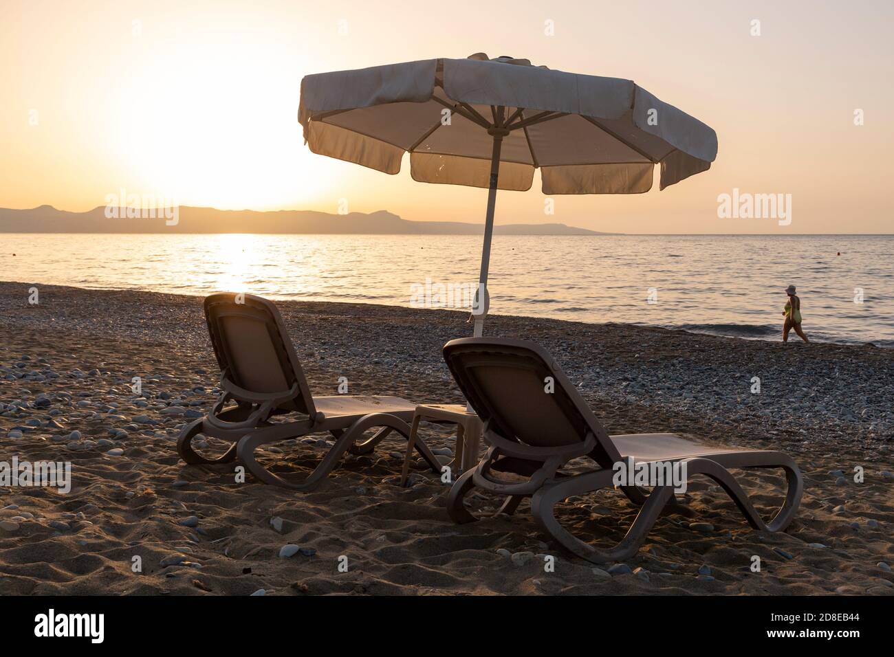Sun loungers and umbrella on Argaka Beach at sunset, Paphos District ...