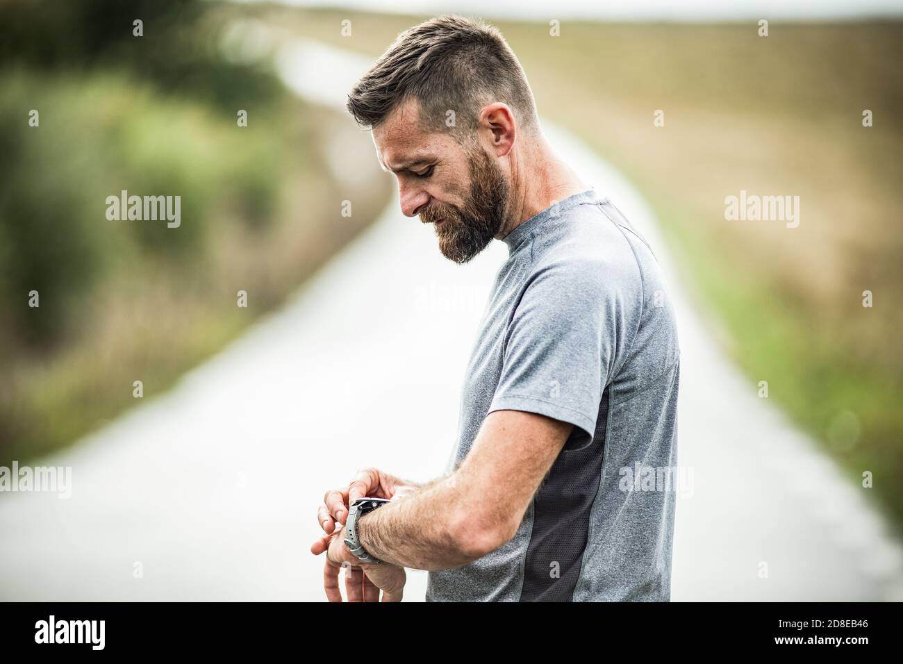 runner checking his smart watch Stock Photo - Alamy