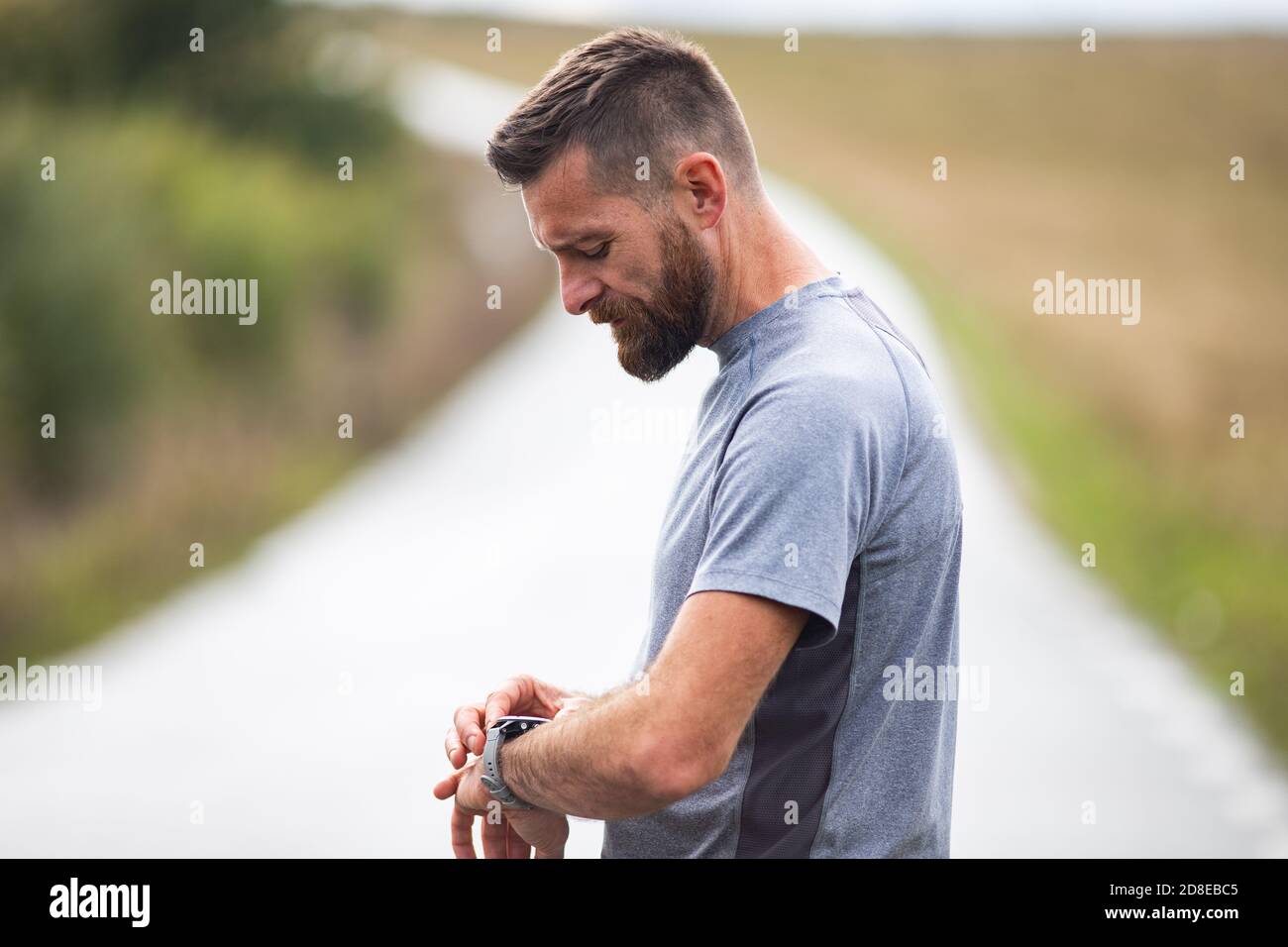 runner checking his smart watch Stock Photo - Alamy