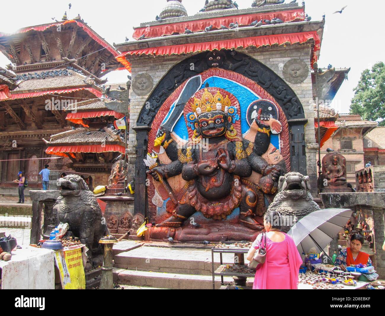 Kathmandu, Nepal - May 2011: A dark stone idol at a shrine to a Hindu ...