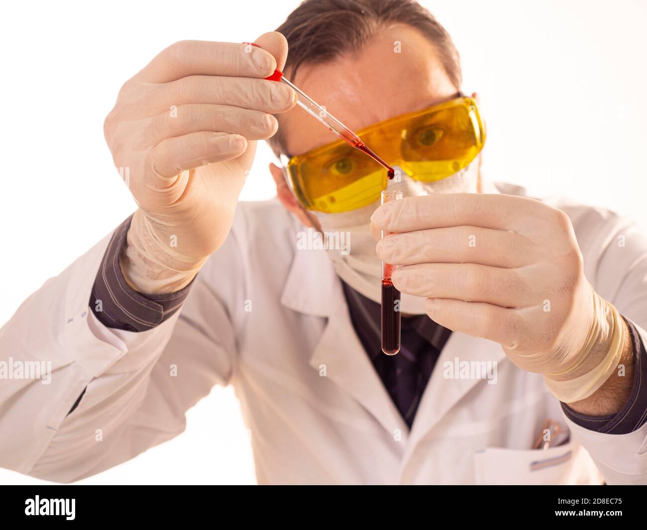 The researcher drops a blood sample into a test tube. Focus on a drop ...