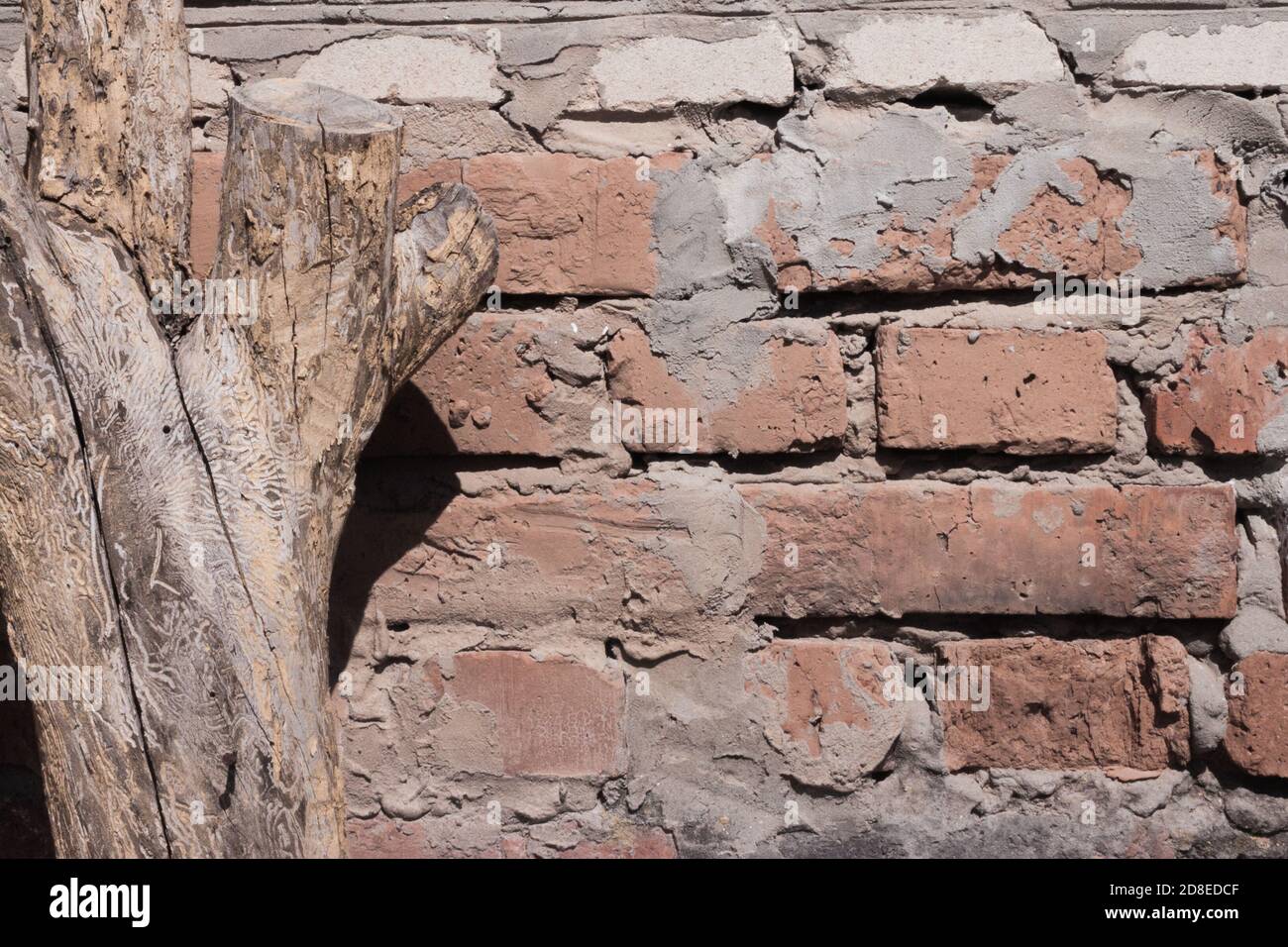 Rough old crumbling orange brickwork. A wall of old broken red bricks ...