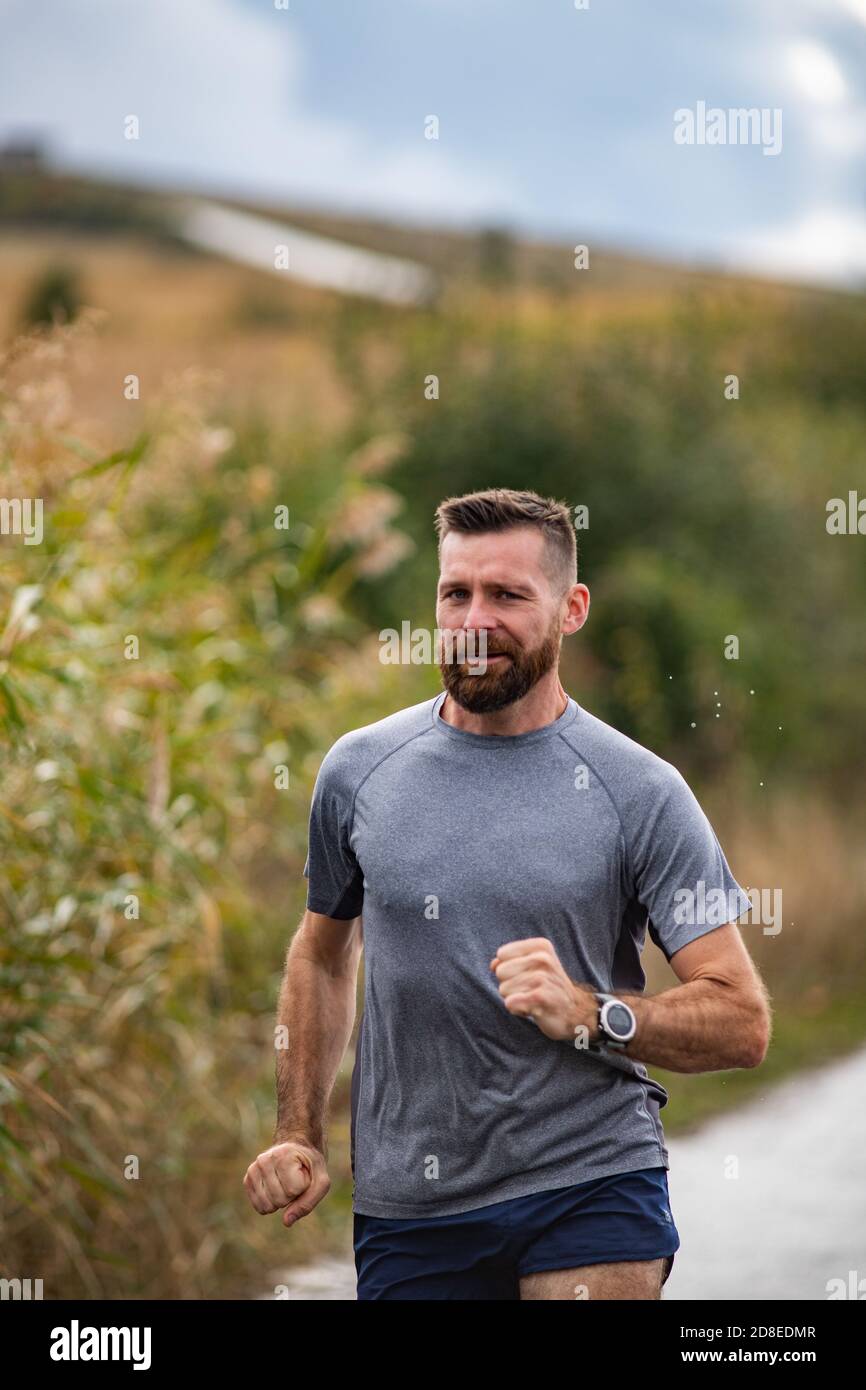young man running on country road Stock Photo - Alamy