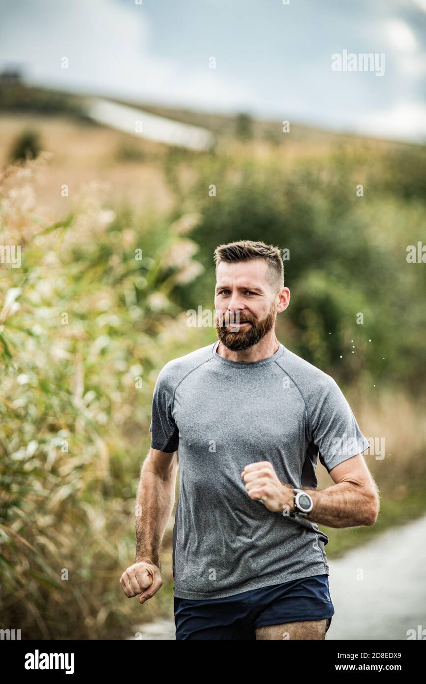 young man running on country road Stock Photo - Alamy
