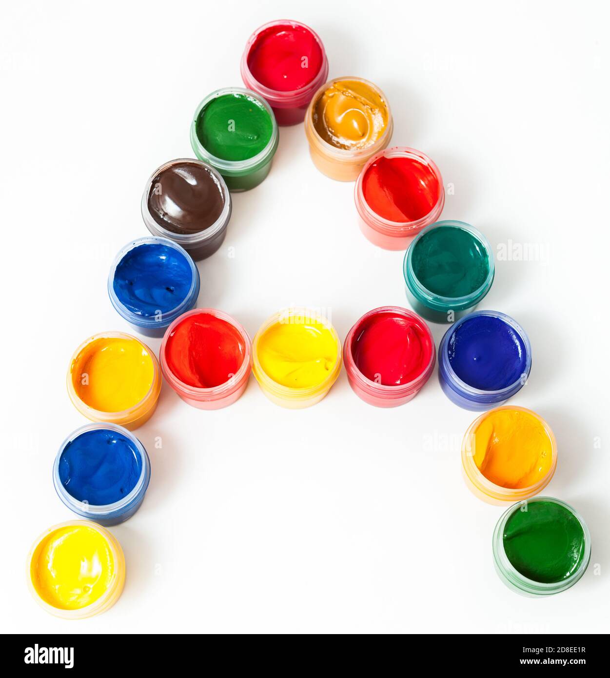 Colorful paints in plastic boxes in shape of A letter, a white ...