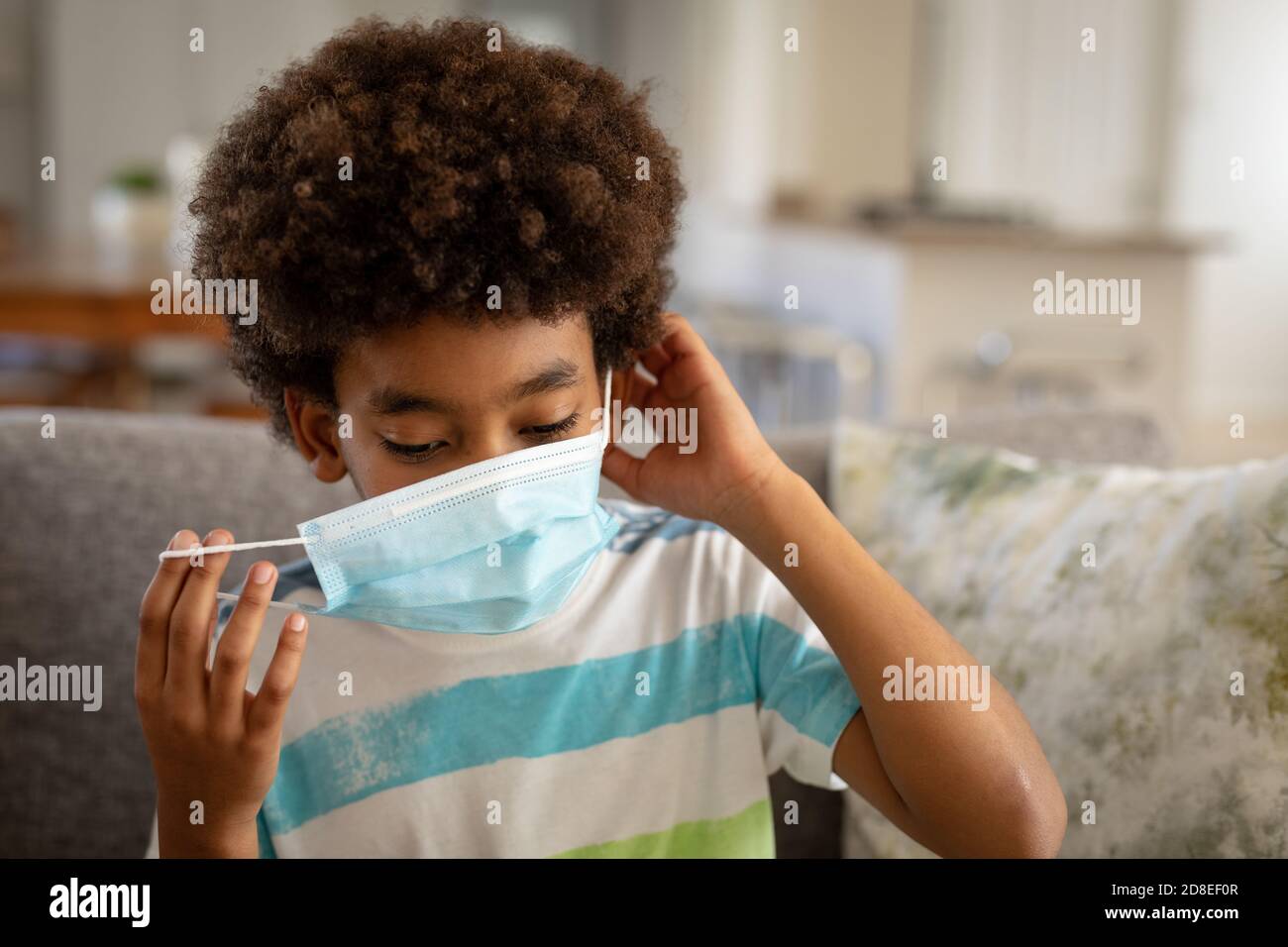 Boy wearing face mask at home Stock Photo - Alamy
