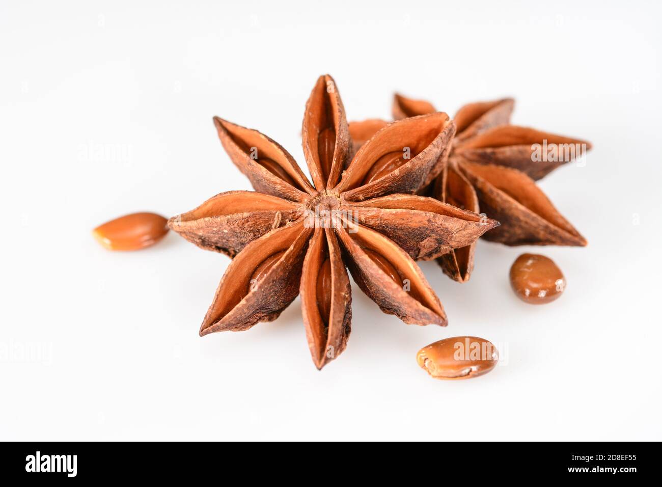 Star anise spice. Two dry star anise fruits with seeds on white ...