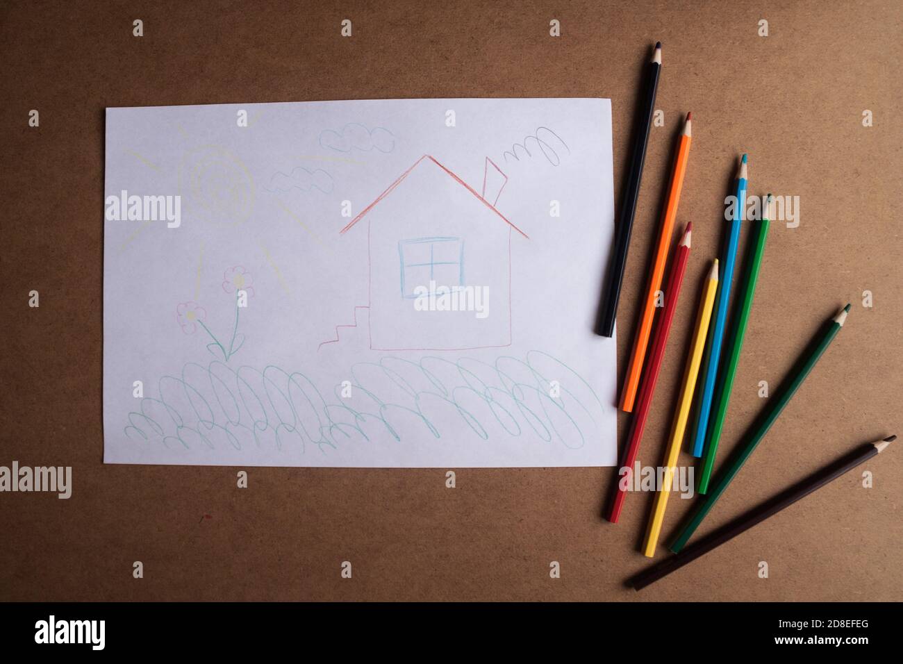 children's drawing and colored pencils lie on the table. children's ...