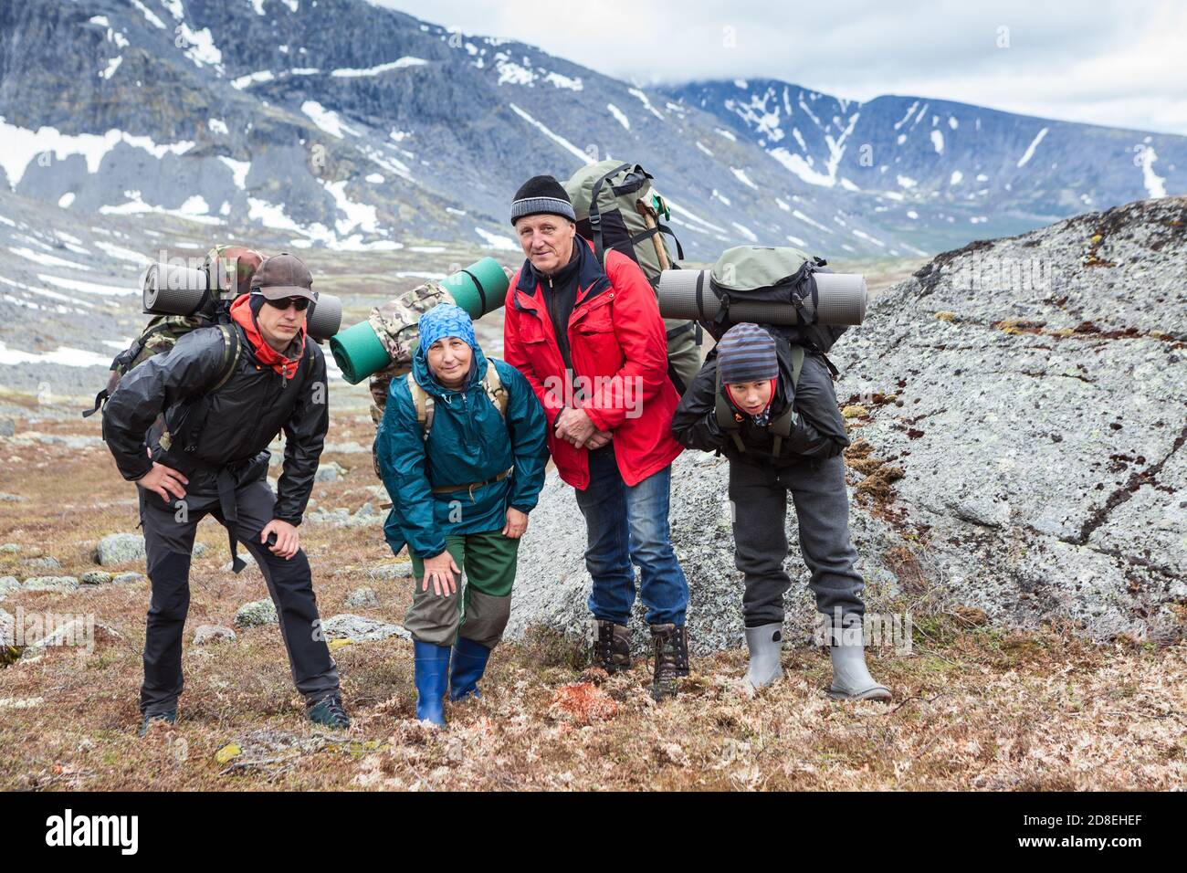 Heavy breathing hikers with big backpacks standing on mountain pass ...