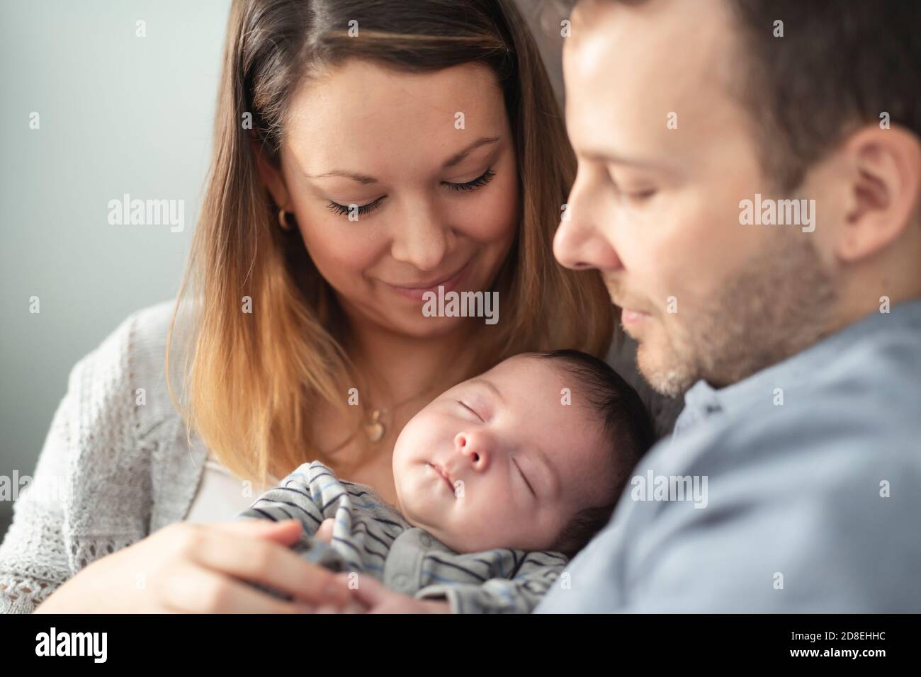 A beautiful couple with newborn Baby on bed Stock Photo - Alamy