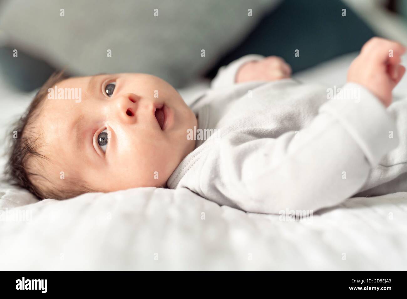 A happy newborn baby on the bed at home Stock Photo - Alamy