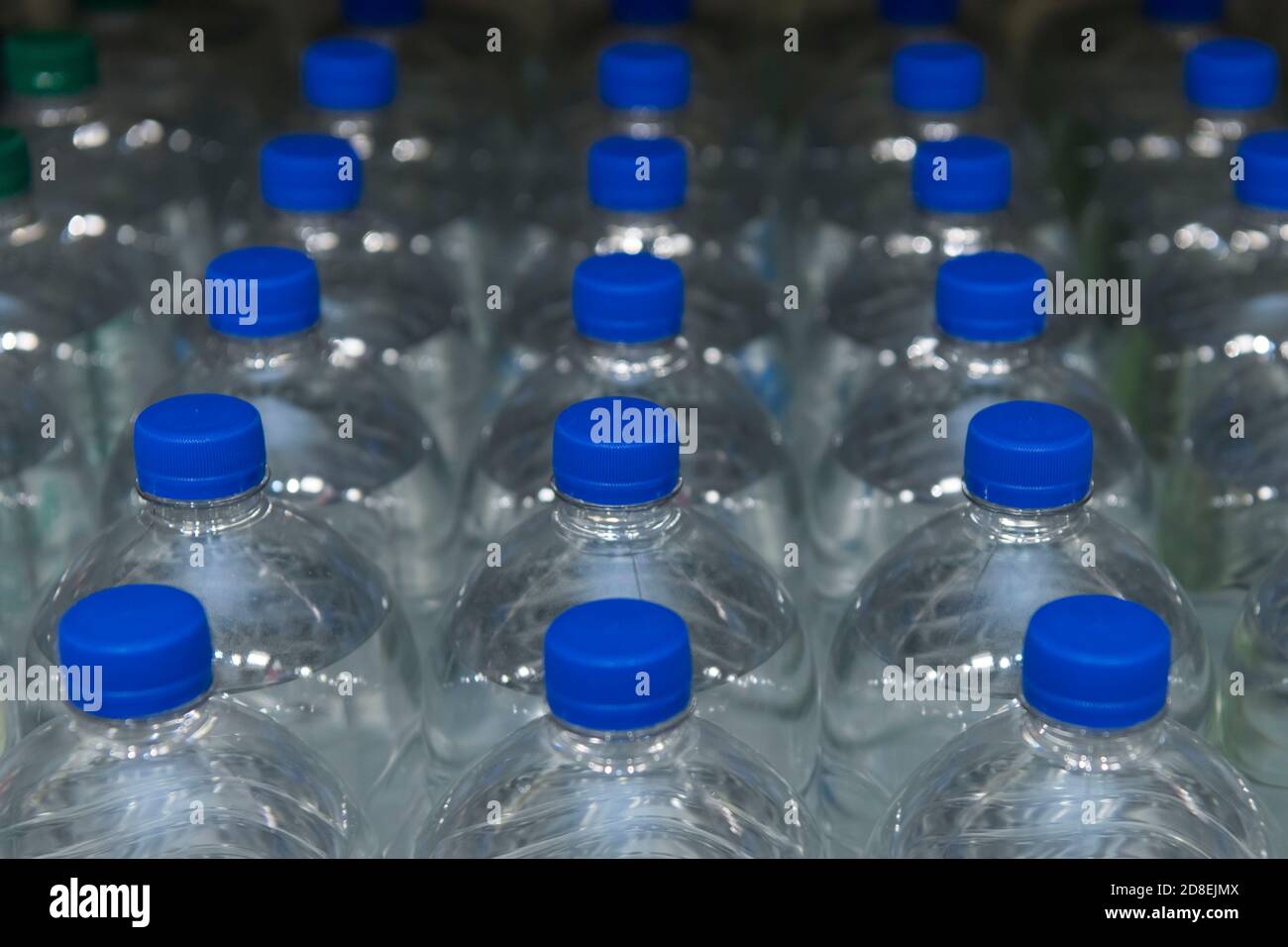 Plastic bottles with blue lids on sale in a supermarket in Cardiff ...