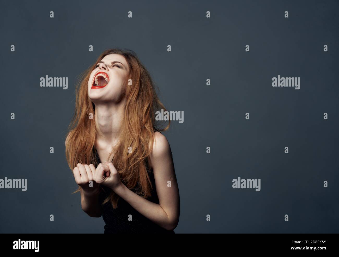 impulsive woman on a gray background indignant Look model and black ...