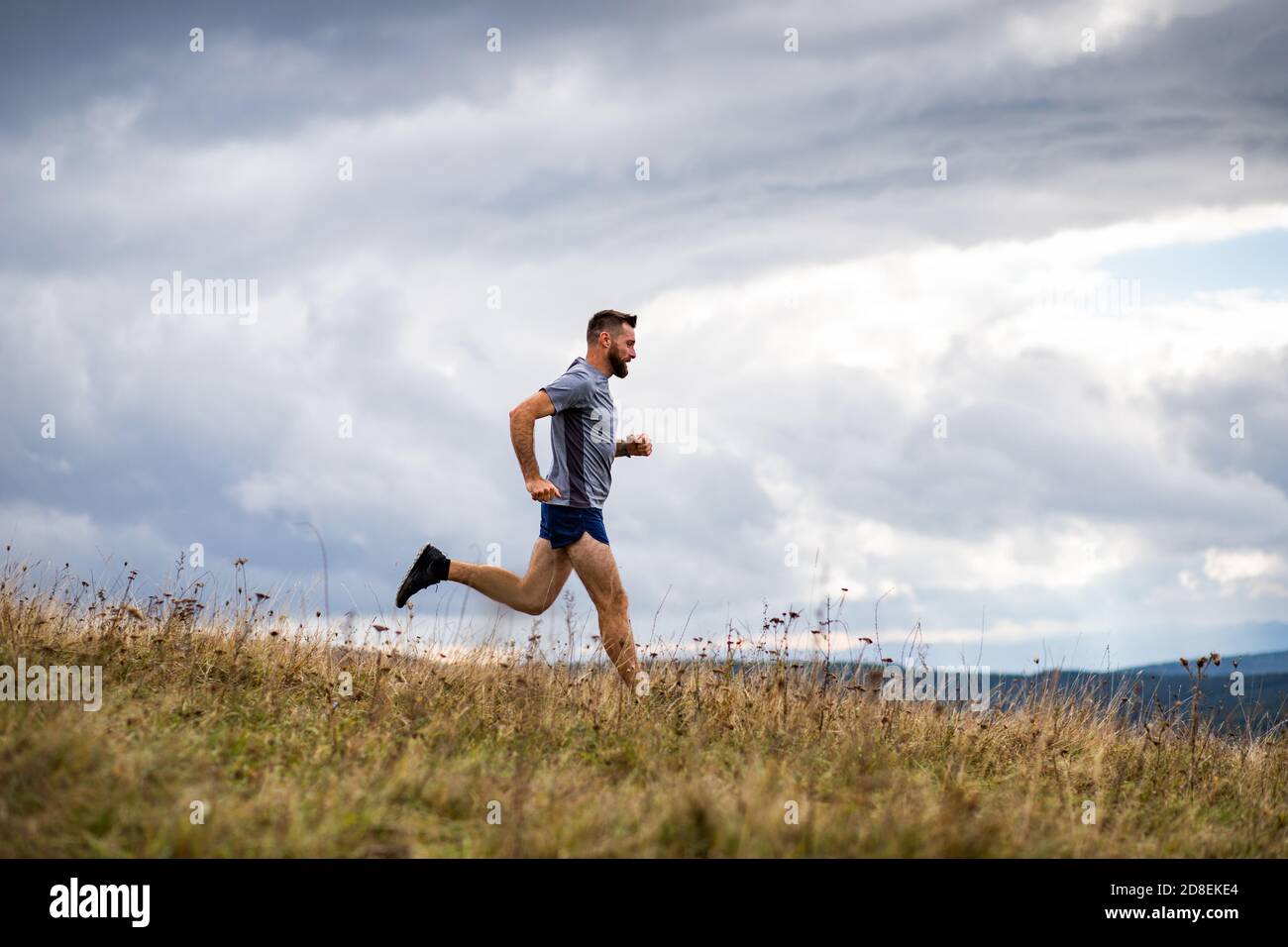 handsome trail runner running in nature Stock Photo - Alamy