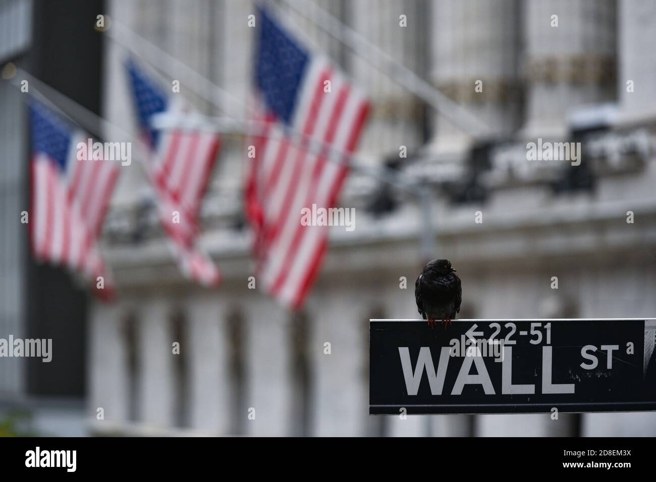 A view of the Wall Street street sign with the New York Stock Exchange ...
