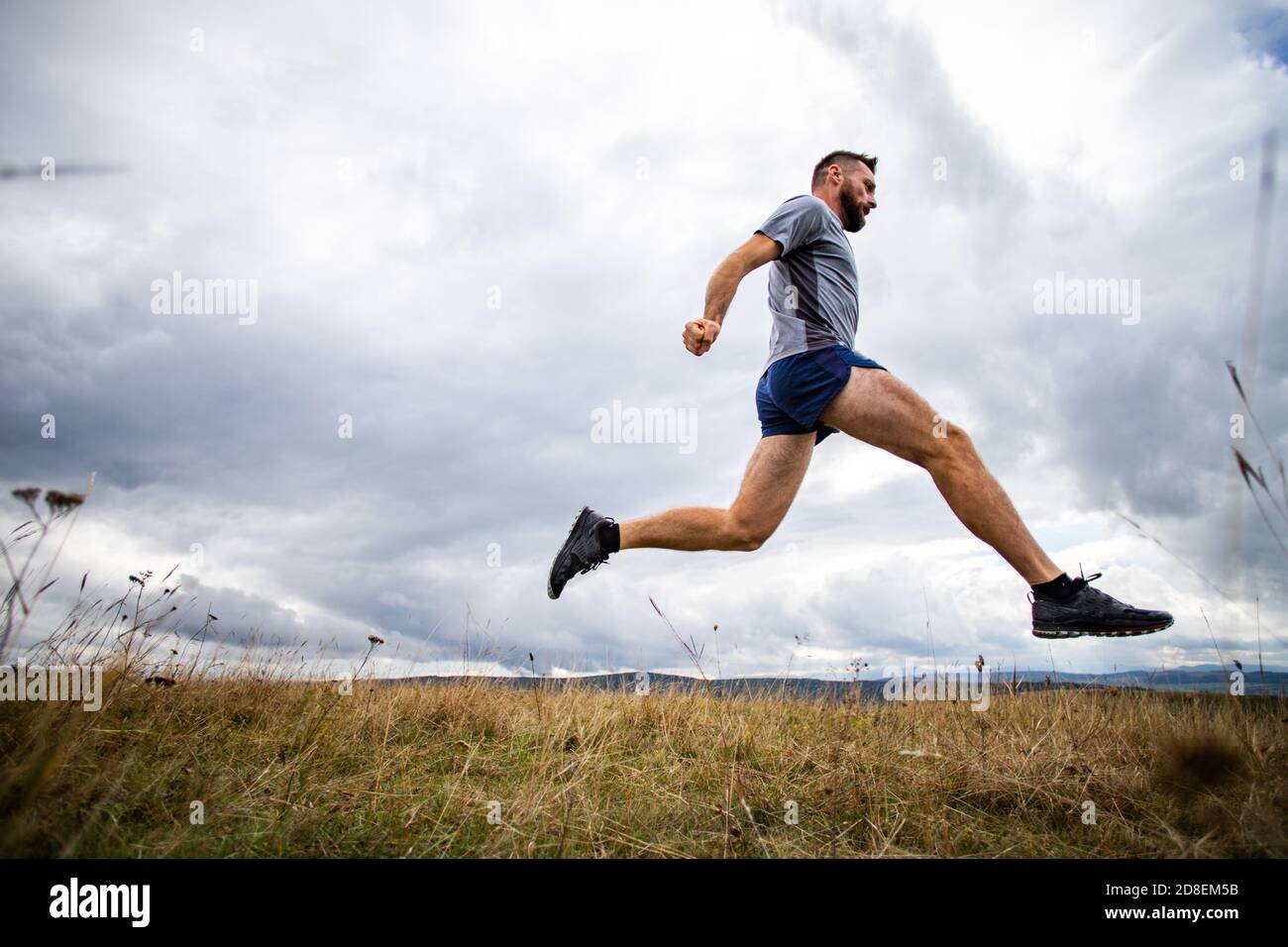 handsome trail runner running in nature Stock Photo - Alamy