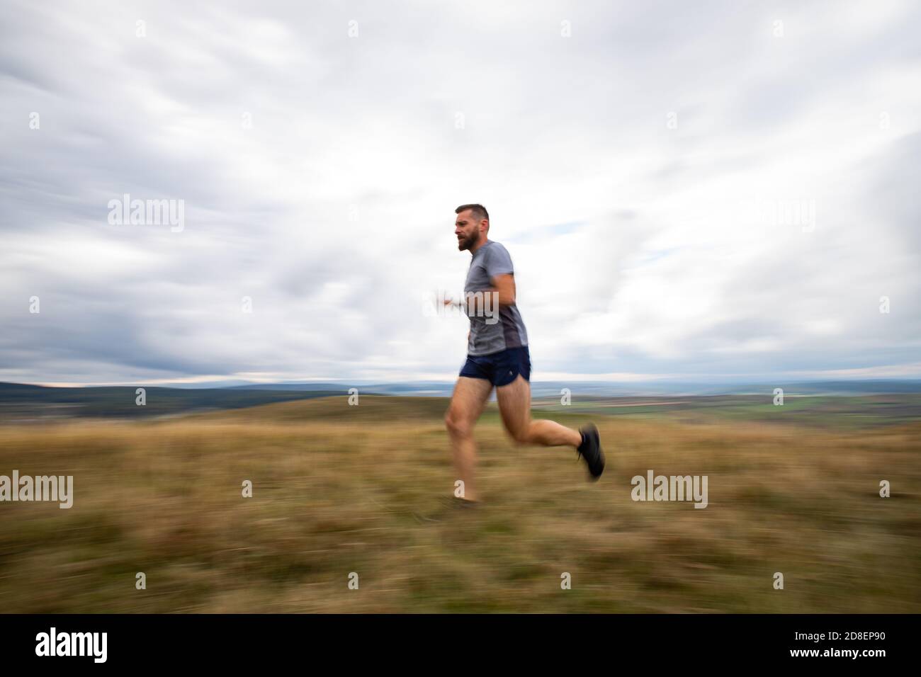 handsome trail runner running in nature Stock Photo - Alamy
