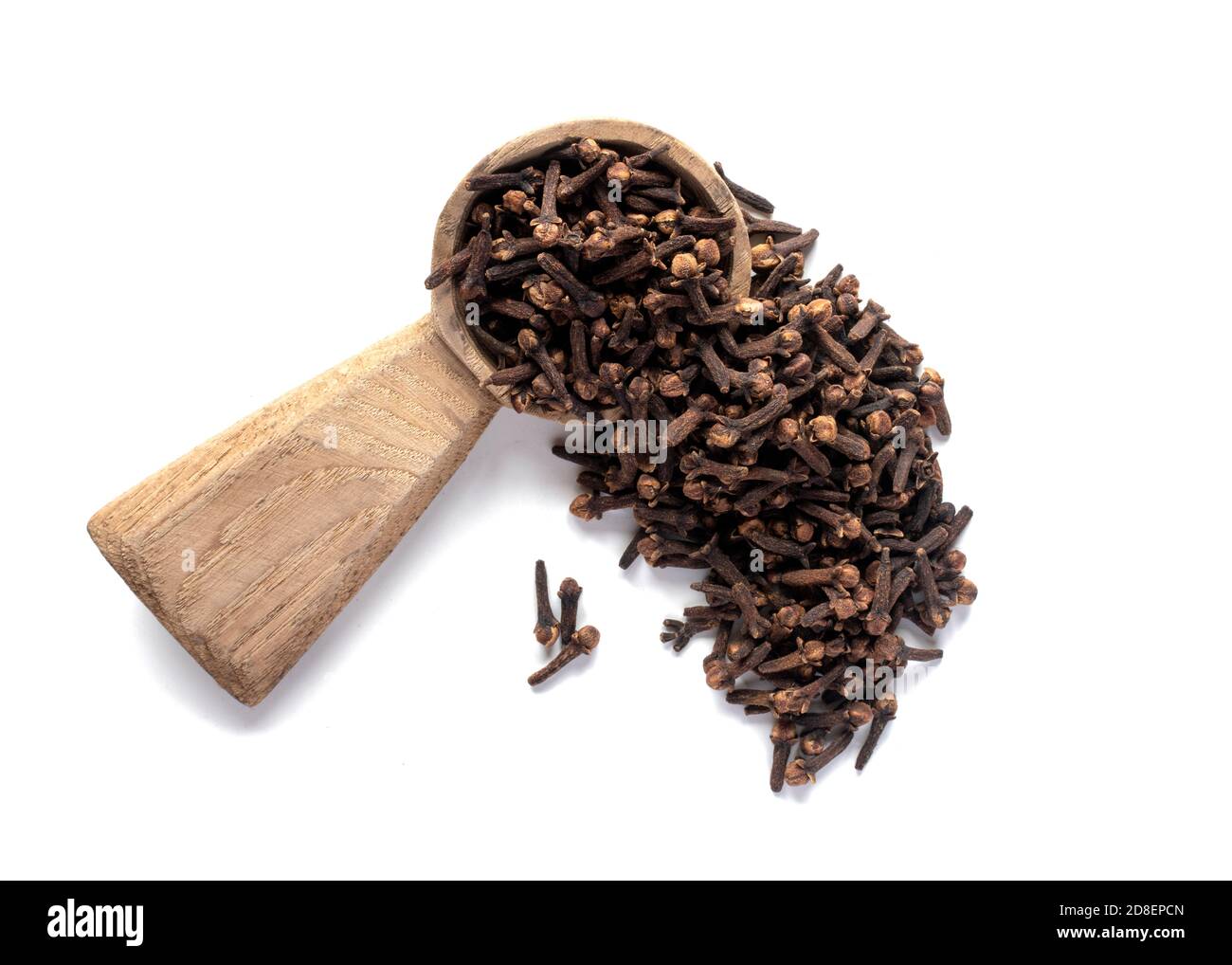 whole cloves in a wooden spoon isolated on a white background Stock ...
