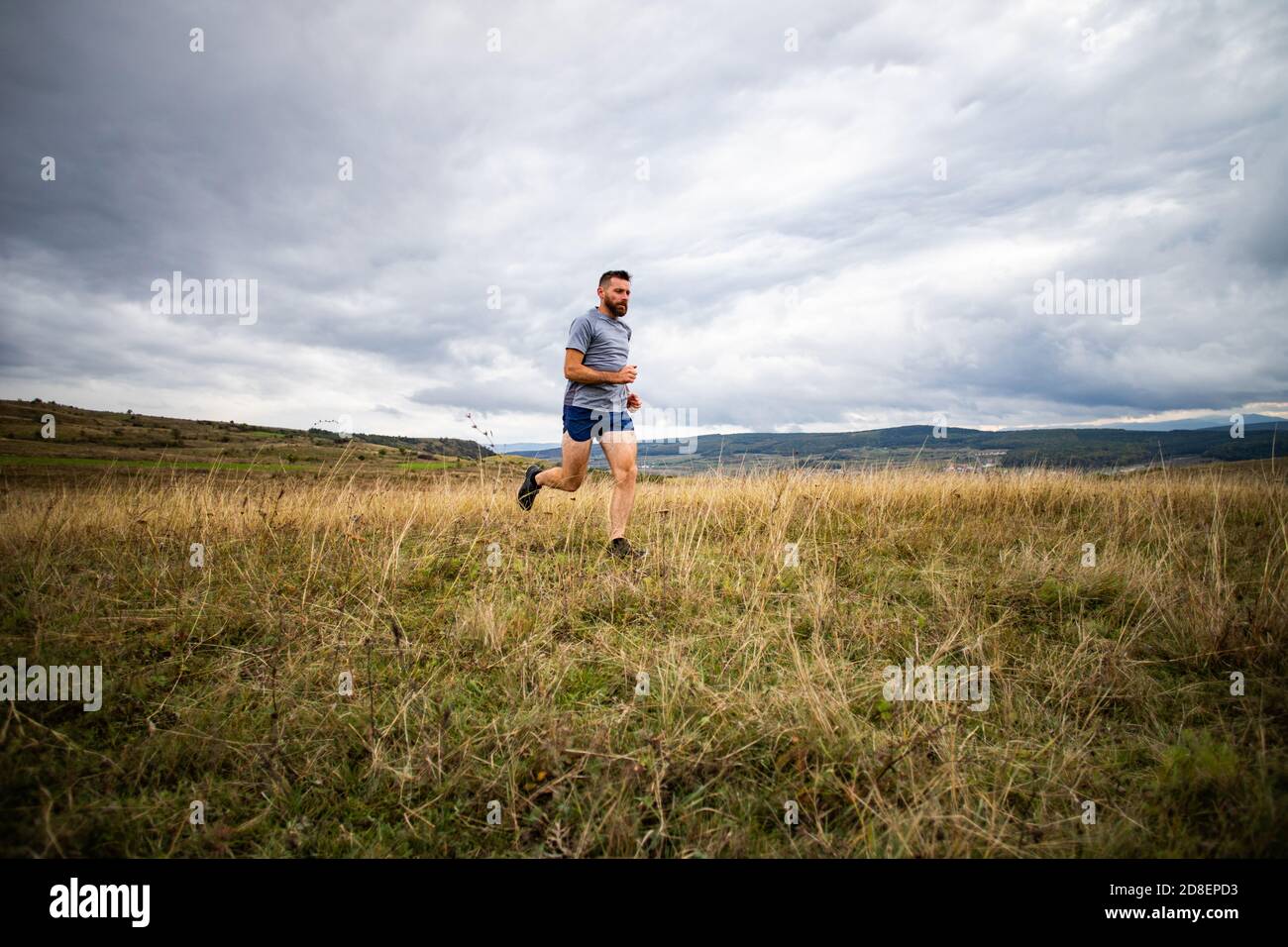 handsome trail runner running in nature Stock Photo - Alamy