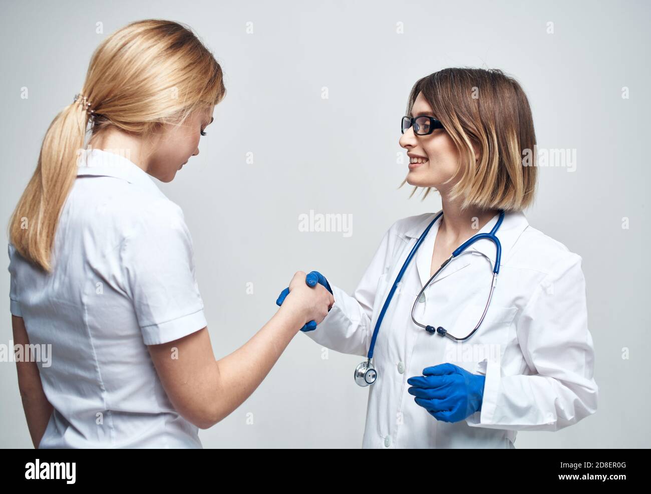 Nurse and patient gestures with hands light background stethoscope ...