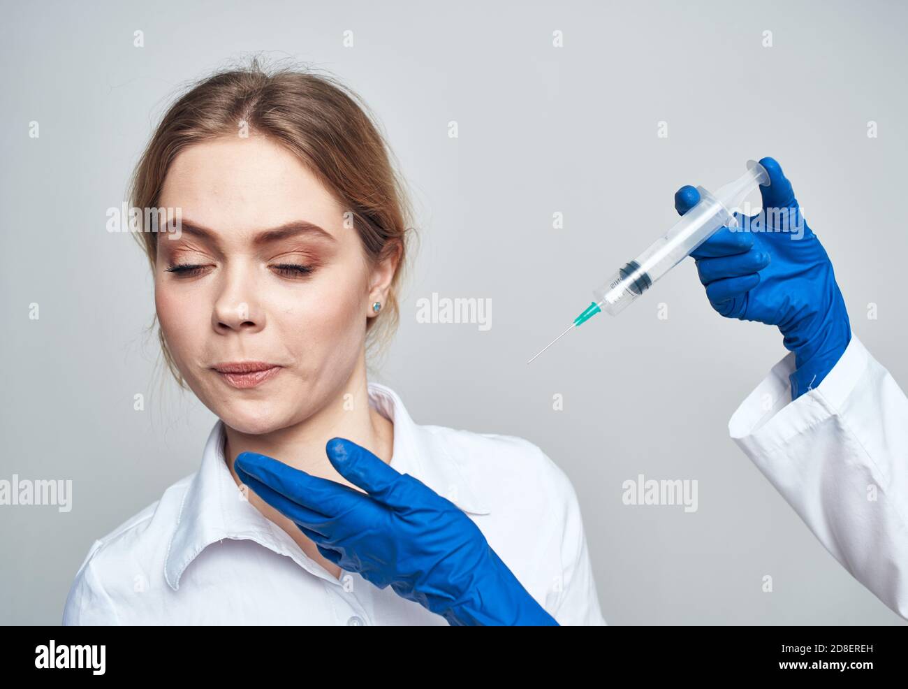 Scared woman and syringe in the hands of the doctor shock emotions ...
